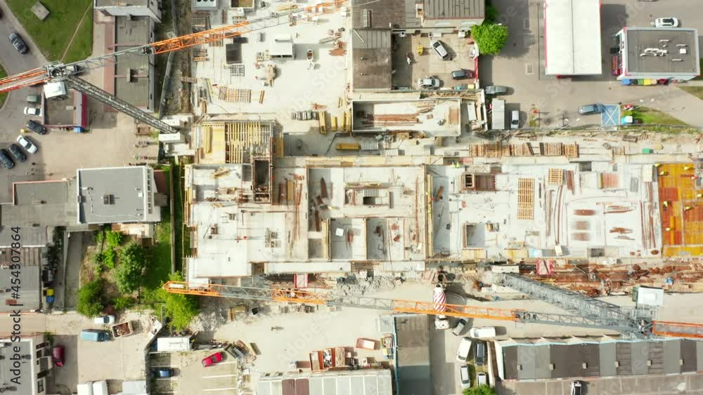 Top-down view of a tall crane working on a construction site with a ...
