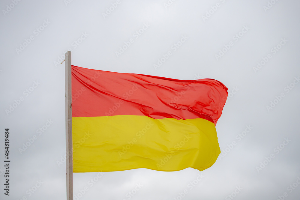 Yellow and red flag waving in the air, This flag represents something ...