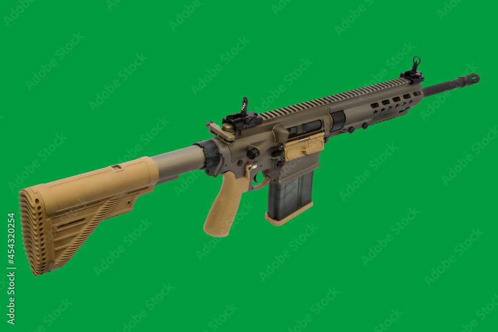 automatic military rifle photographed against a green background ...