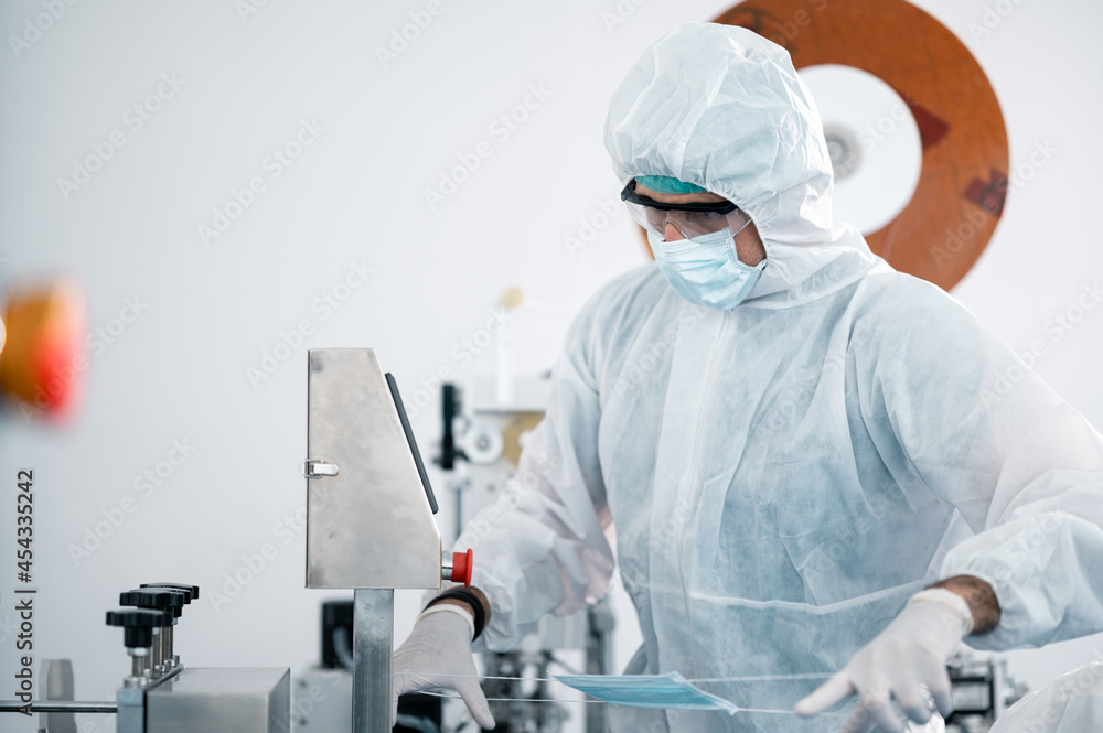 Scientists wearing uniform protection. Check the manufacturing process ...