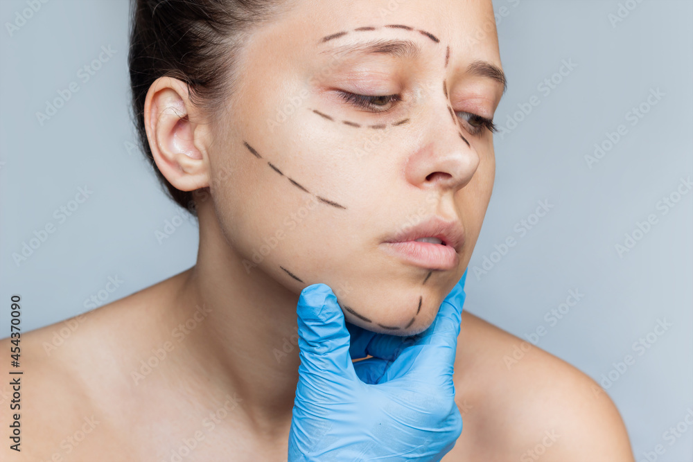 Cropped shot of a young caucasian woman with marking on her face on a ...