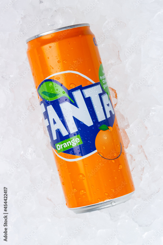 Fanta orange lemonade soft drink in a can on ice cubes portrait format ...