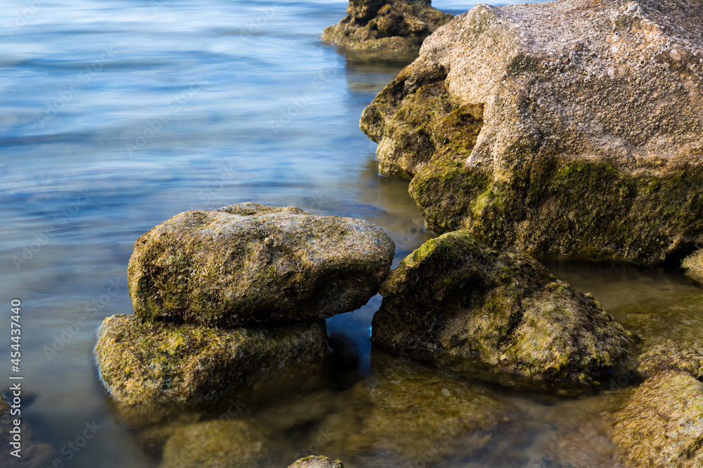 stones in the sea of Holbox Island, Mexico where you can see multiple ...