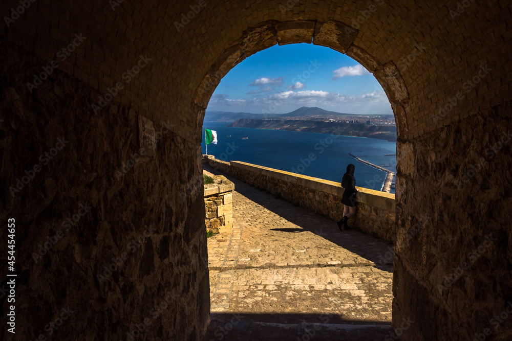 Lonely woman looking at the horizon at Fort Santa Cruz, one of the three forts in the city of ...