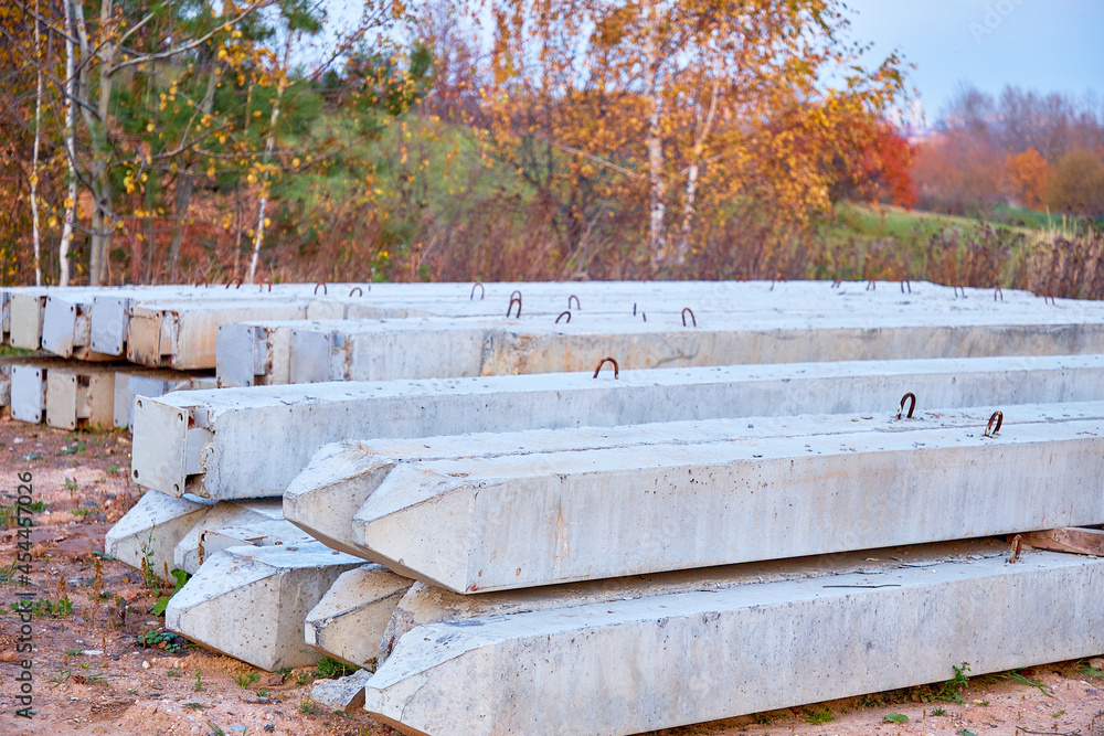 Stock of concrete piles at the construction site. Concrete Driven Piles ...