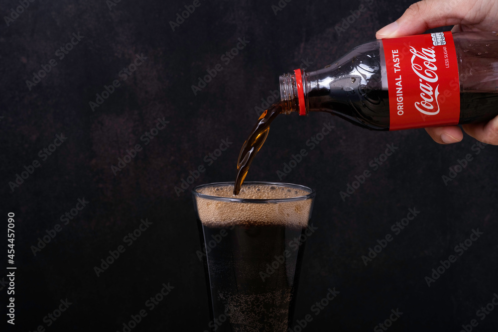 Nonthaburi, Thailand August 15.2021:Photo of hand pouring Coca-Cola or ...