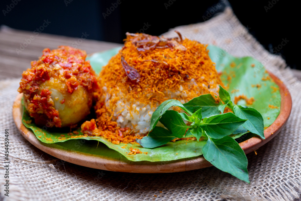 Nasi Ulam, basil leave, with spicy boiled eggs on banana leaf ...