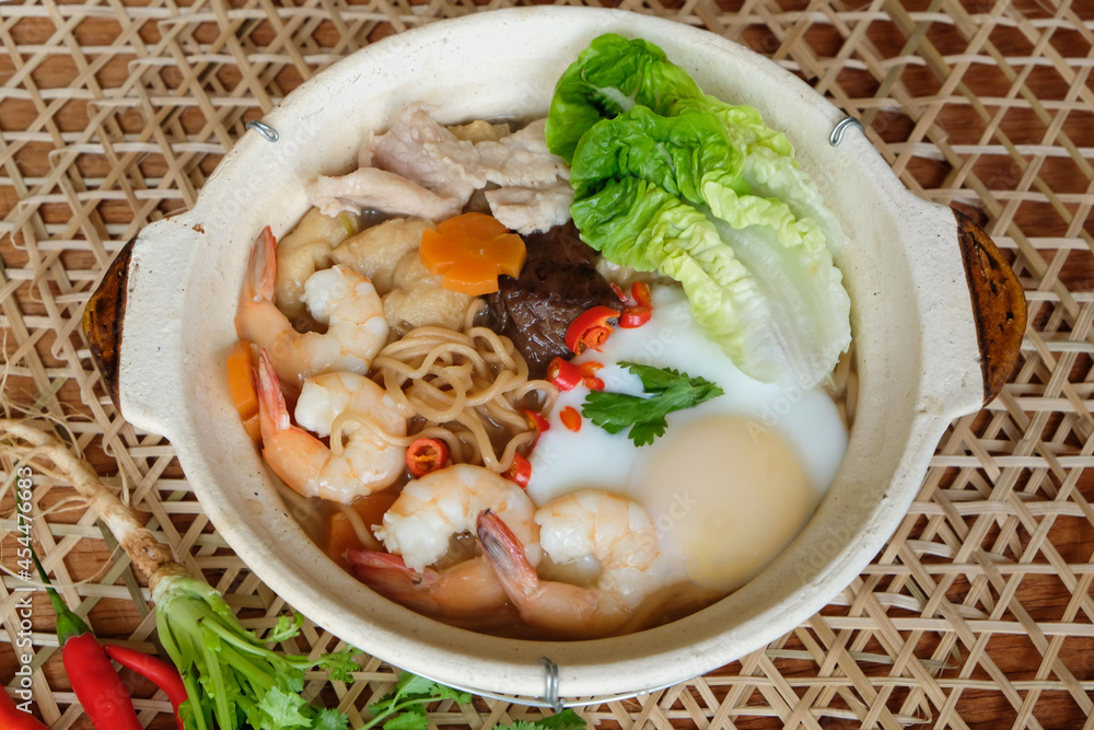 Homemade Chinese cuisine. Claypot Yee Mee Noodle Soup. Broth made from ...