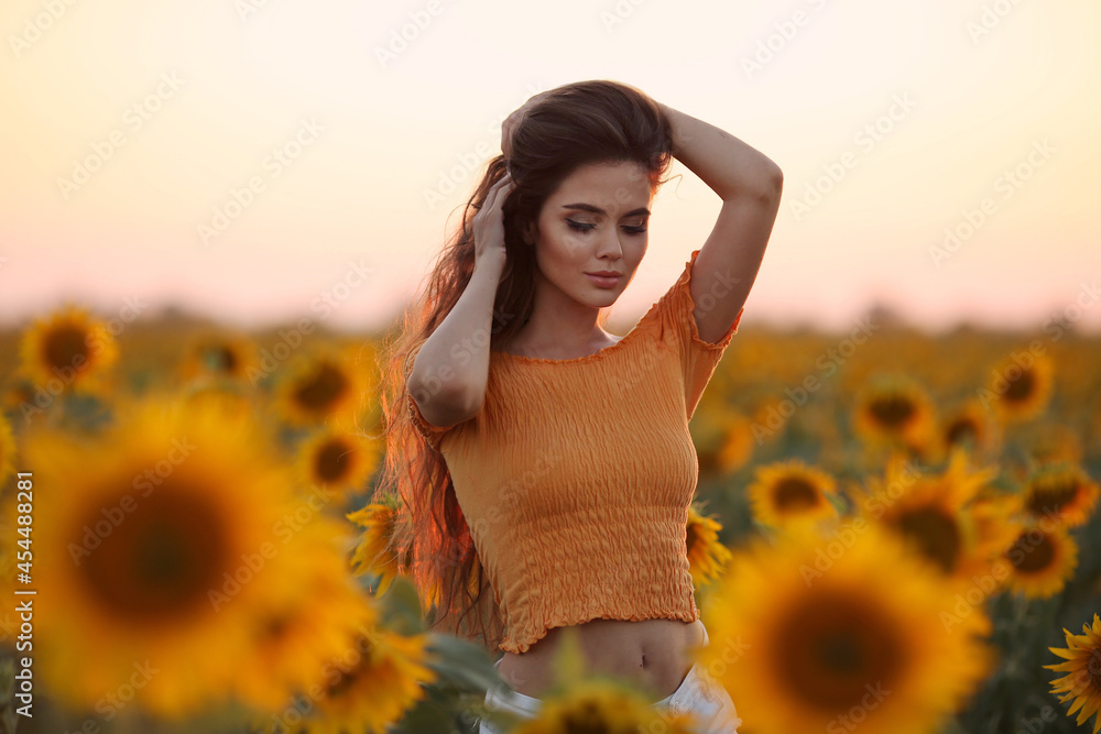 Beautiful young girl enjoying nature on the field of sunflowers at ...