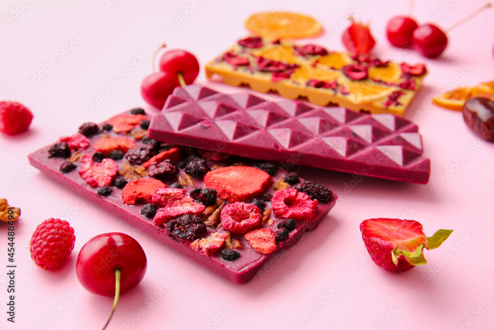 Handmade chocolate bars with fruits, berries and nuts on color ...