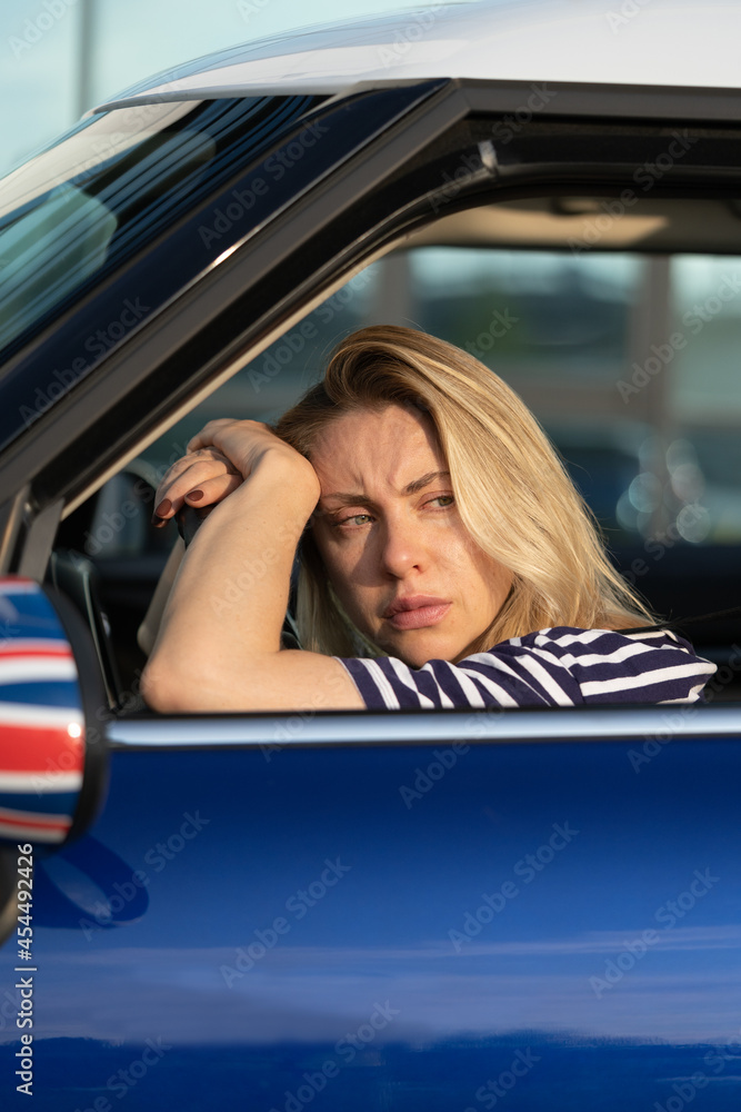 Bored woman driver in car waiting for tow truck. Middle aged female ...