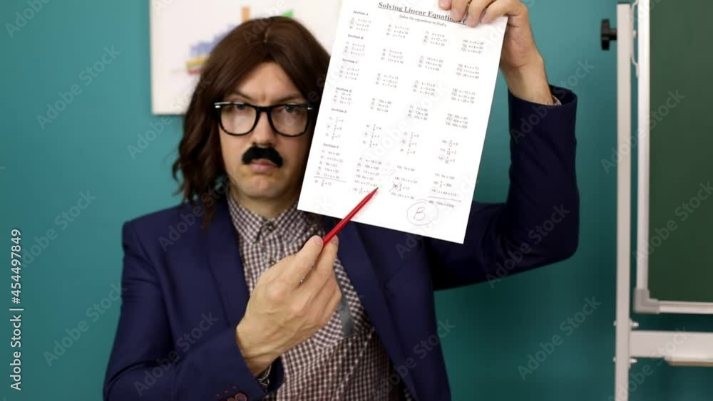 Funny angry school teacher with a mustache wearing glasses shows the ...