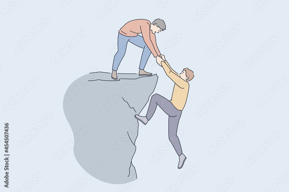 Helping hand and assistance concept. Young man standing on peak of rock ...