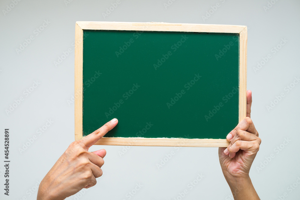 Isolated small blackboard with fingers,hands pointing towards board ...