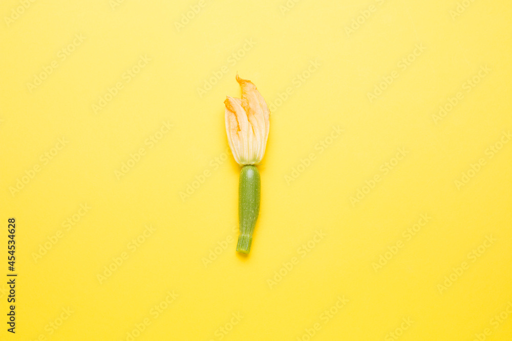 Zucchini and zucchini flowers on a bright yellow background. Stock ...