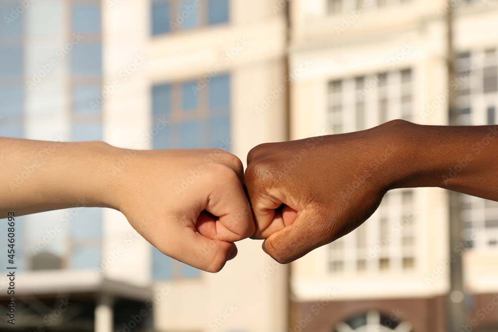 Men making fist bump on city street, closeup Stock Photo | Adobe Stock