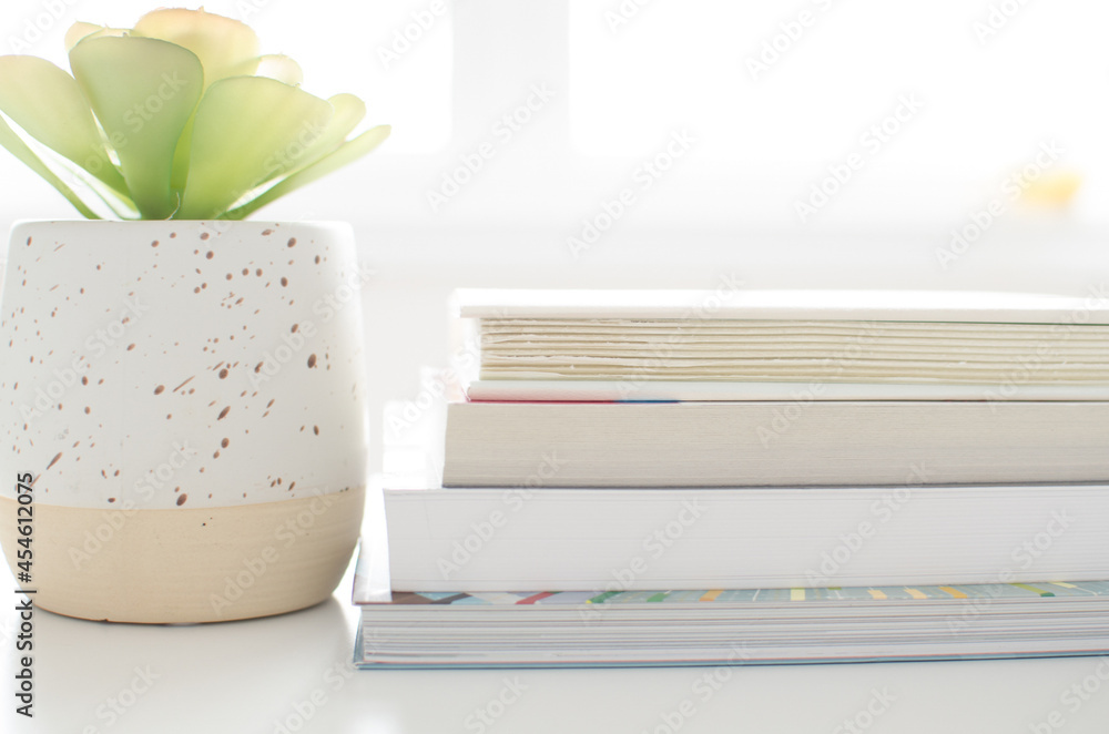 Books on the desk with white background, light colors, neutral colors ...