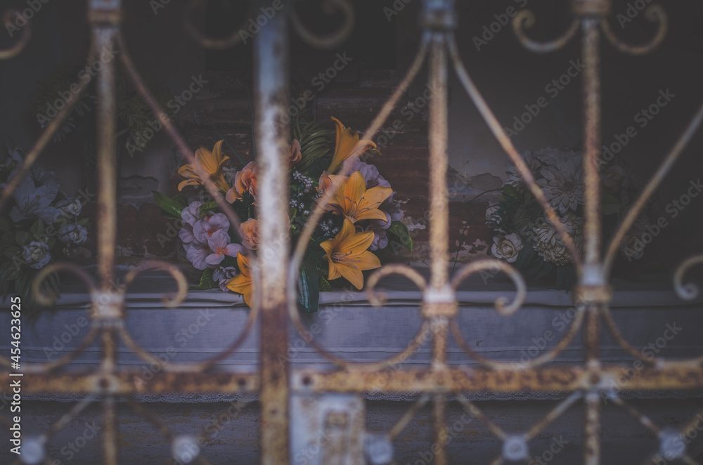 All Saints Day in the cemetery, grave behind iron rusty gate Stock ...