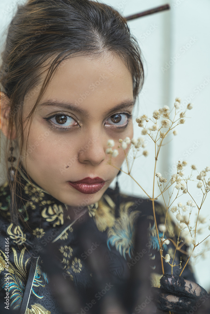 Artistic Portrait of a beautiful Eurasian Girl dressed up with a green ...