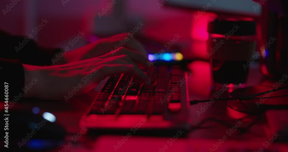computer hacker typing on keyboard hacking data on internet cyber crime ...