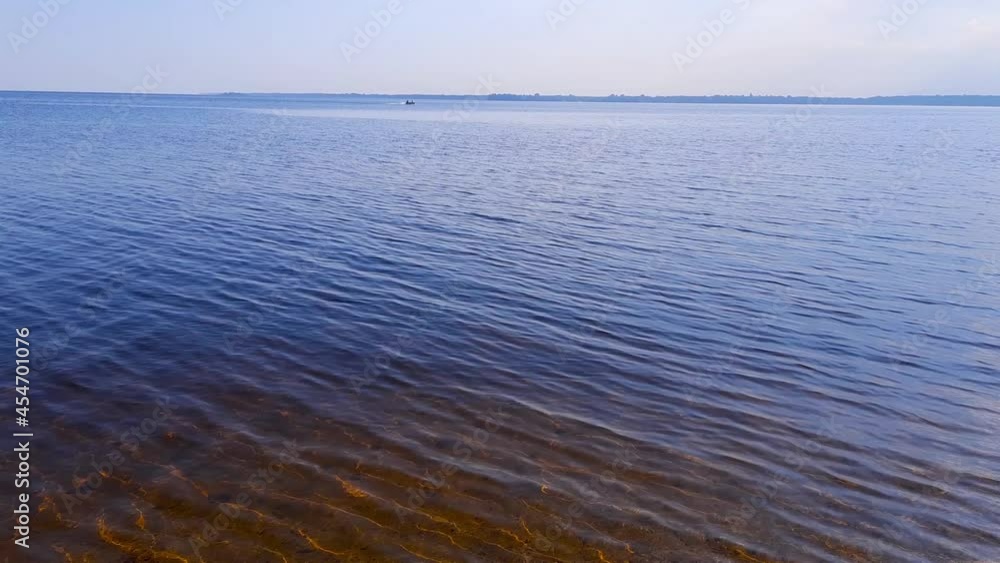 Water surface of large reservoir next to coast with slight agitation ...