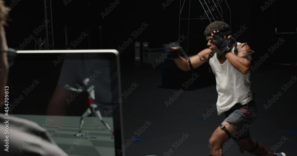 man wearing motion capture suit in studio performing martial arts actor ...