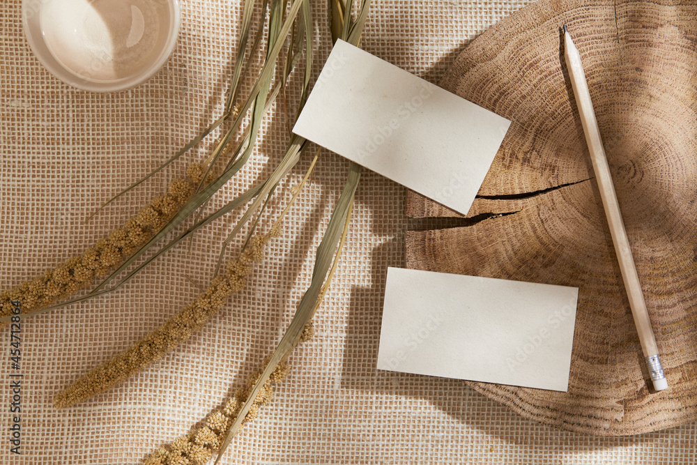 Flat lay of creative composition with mock up visit cards, textile ...