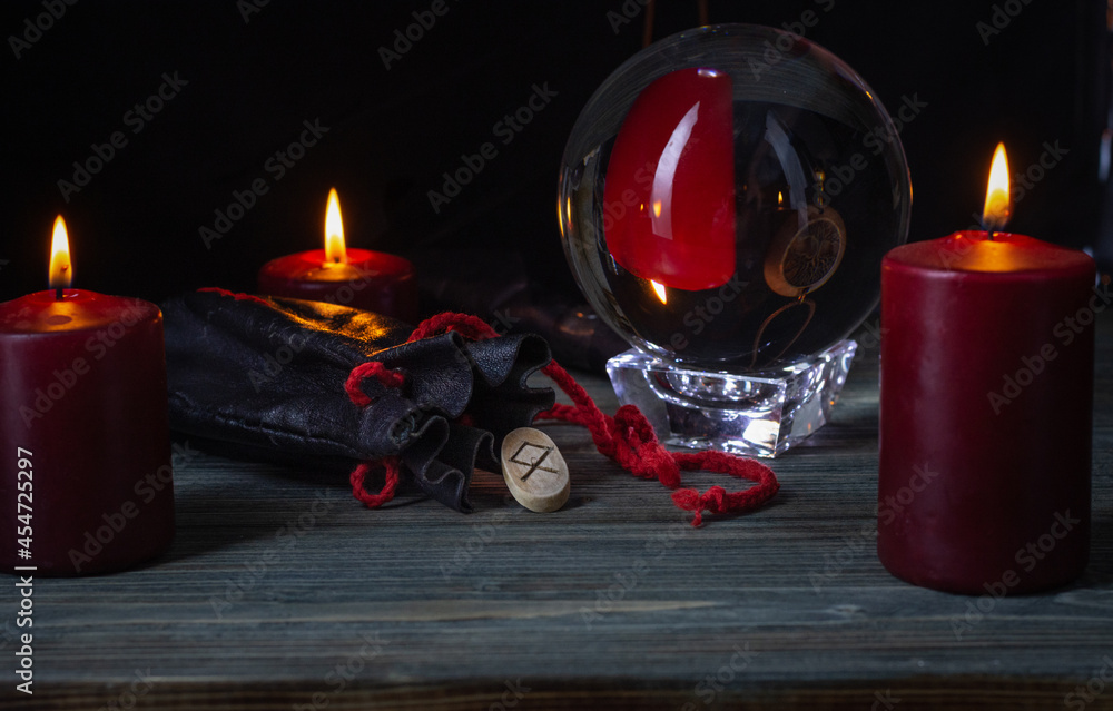 Foto de Burning candles, crystal ball, old leather bag for Scandinavian ...