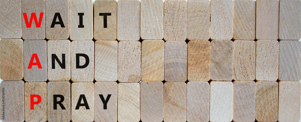 WAP, Wait and pray symbol. Wooden blocks with concept words 'WAP, Wait ...