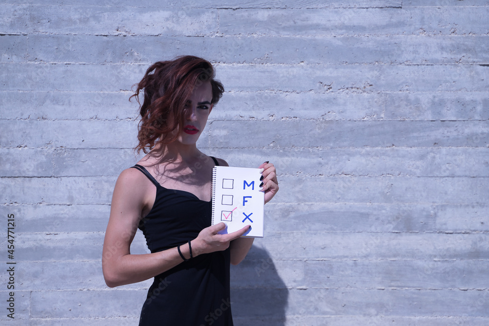 Young Hispanic and transgender girl pointing out in a notebook the ...