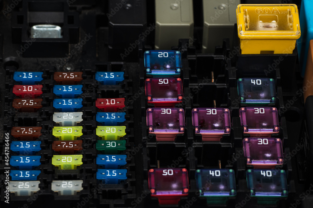 Automotive fuses on a black panel with holders and multi-colored ...