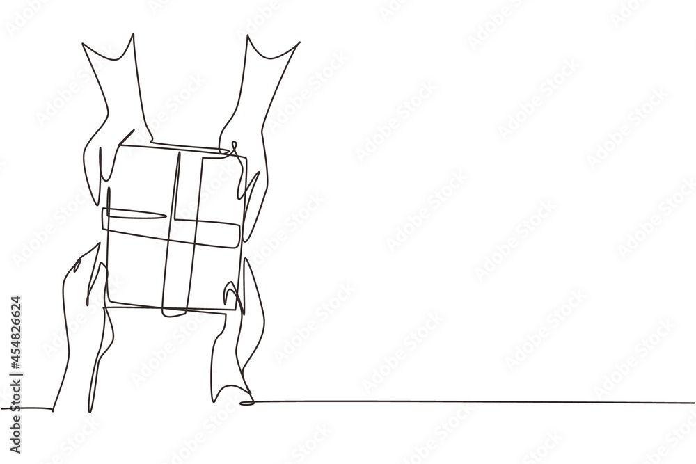 Single one line drawing gives gift box presents laid on wooden table ...