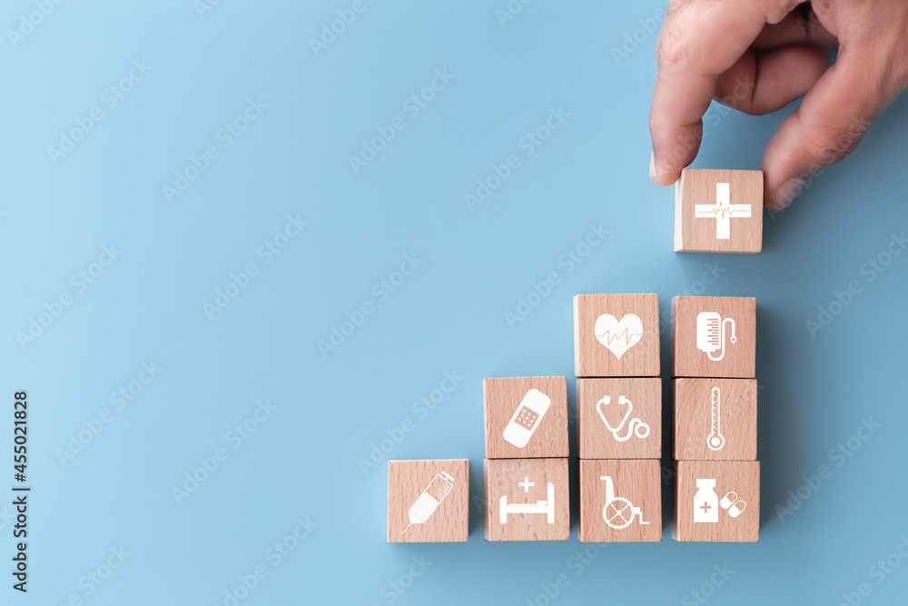 Health Insurance Concept, hand arranging wood block stacking with icon ...