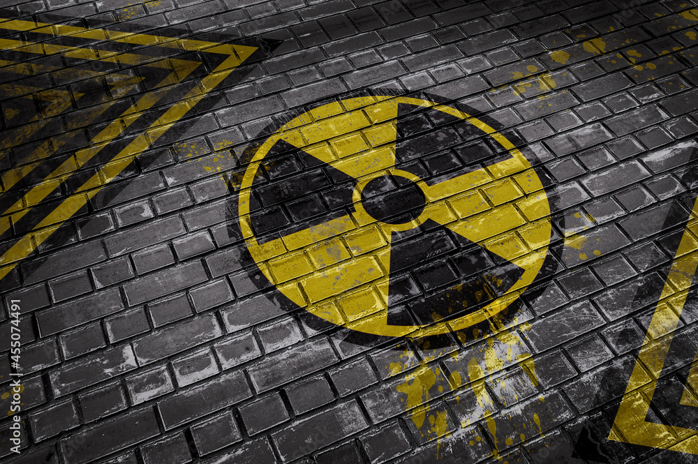 3D illustration depicting a brick wall with a radioactive hazard sign ...