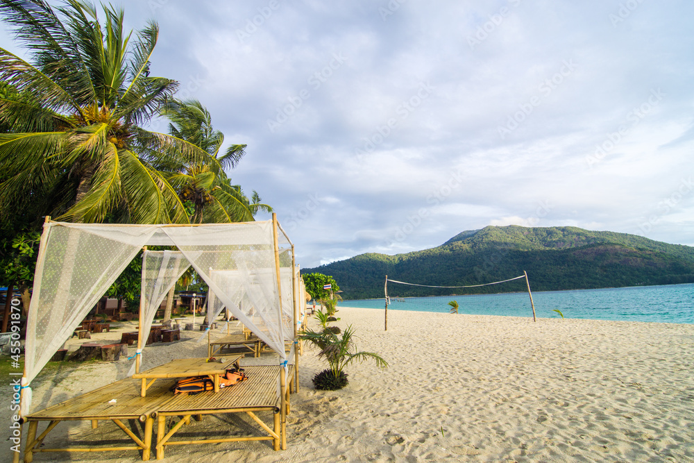 Wooden beach bench on white sand beach with coconut palm tree summer ...