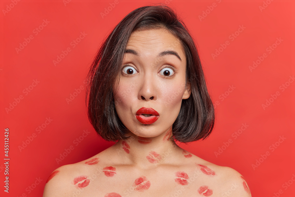 Beautiful shocked Asinan woman stares in stupor has red painted lips ...