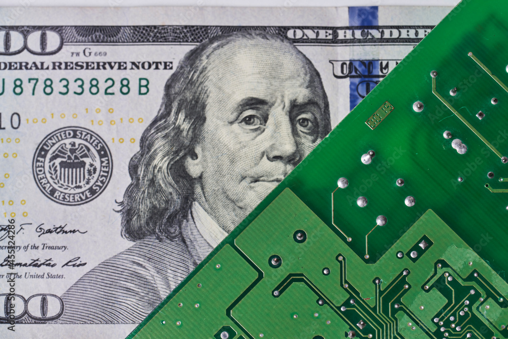US dollar banknote and printed circuit board. Electronic board and 100 ...