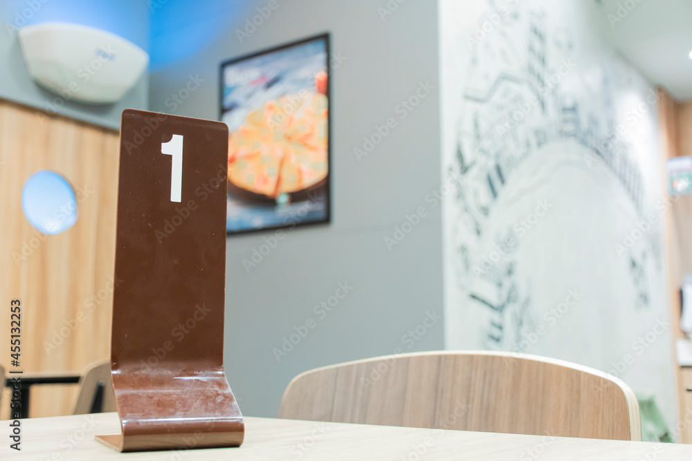 Sign number 1 is located on the dining table inside the restaurant ...