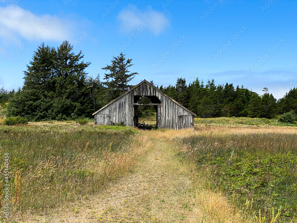 old barn in the field old rundown barn farm building in an empty field ...