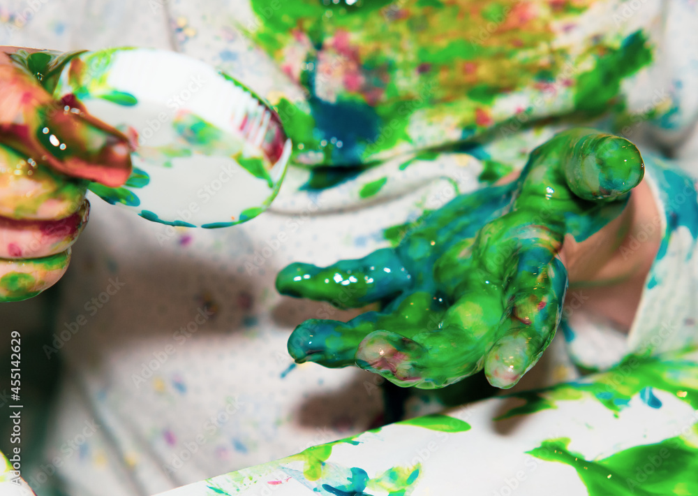 Finger coloring for kids. A little girl draws with paints with her ...