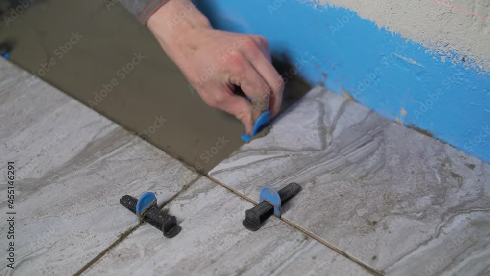 Laying the floor with ceramic tiles. Floor repair. Ceramic tiles. The ...