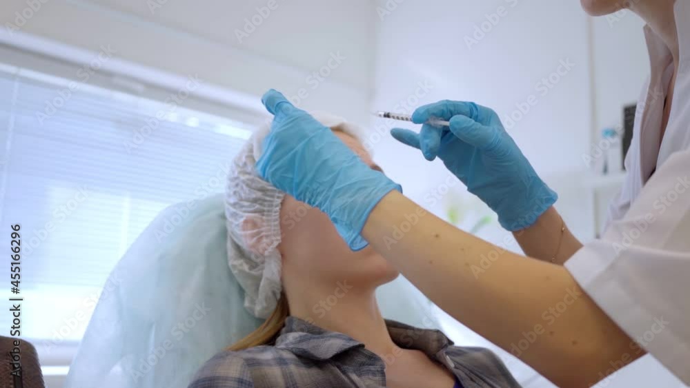 girl injected with botulin into skin of face. rejuvenating procedure in ...