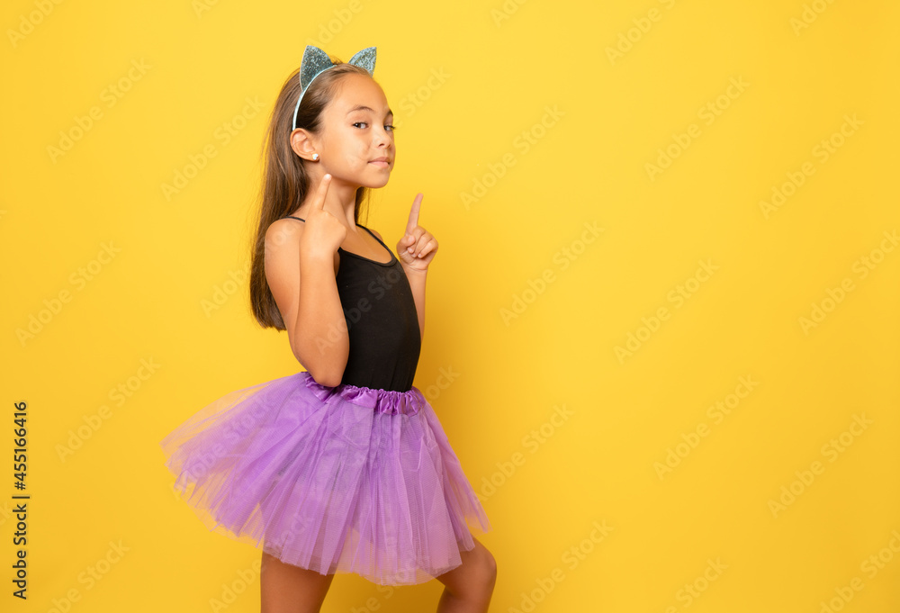 Beautiful little girl in Halloween costume pointing fingers up isolated ...