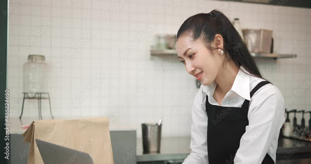 Asian female waitress cashier typing online order coffee and bakery ...