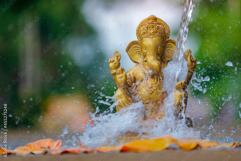 Water splash on lord ganesha sculpture. celebrate lord ganesha festival ...