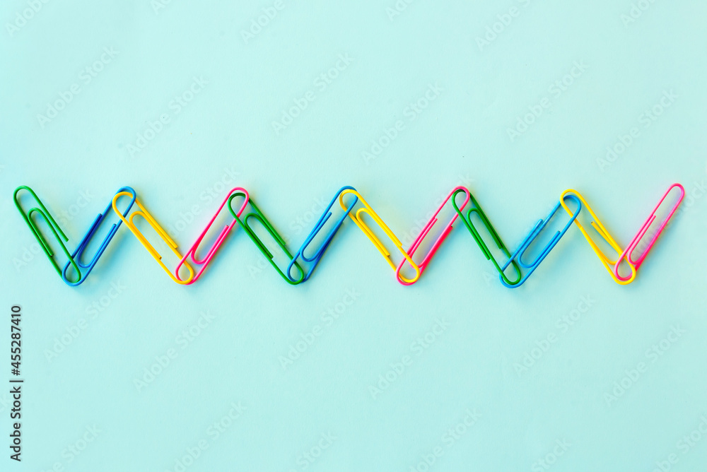 Colorful paper clips stuck together in a chain. Concept of human ...
