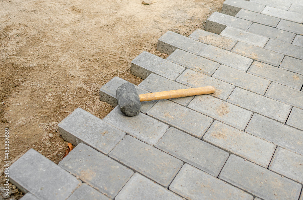 Hammer for sealing the pavement on the newly laid pavement. The process ...