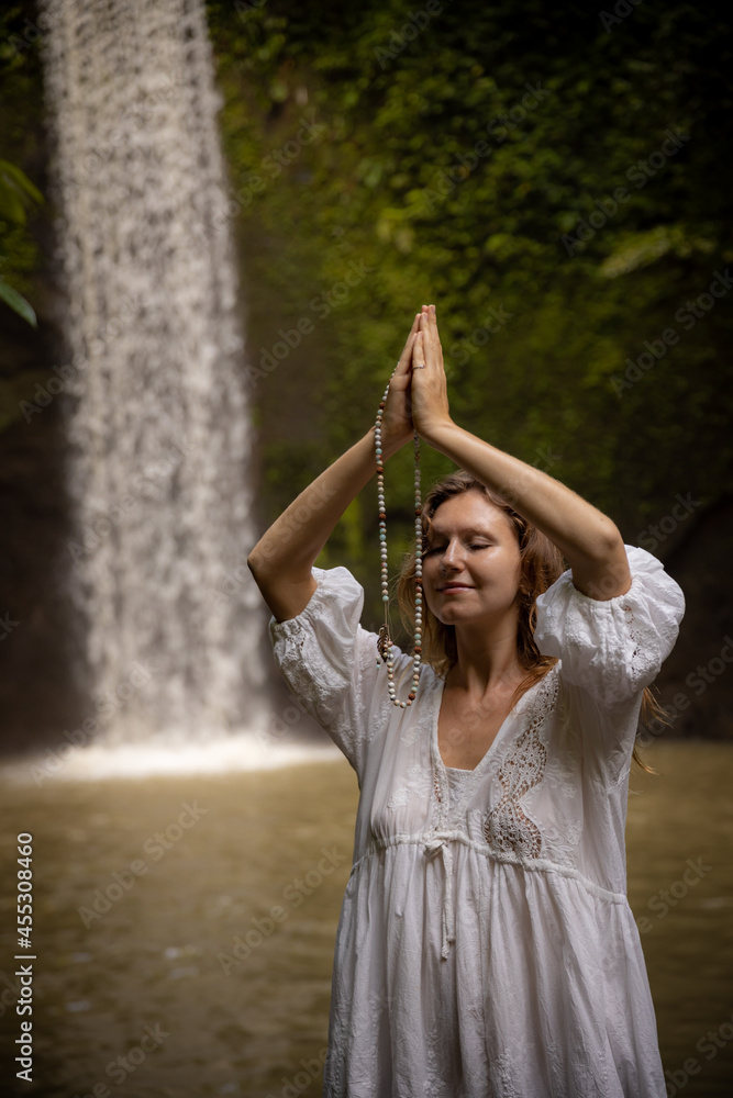 Caucasian woman keeping count during pray and meditation. Buddhist japa ...