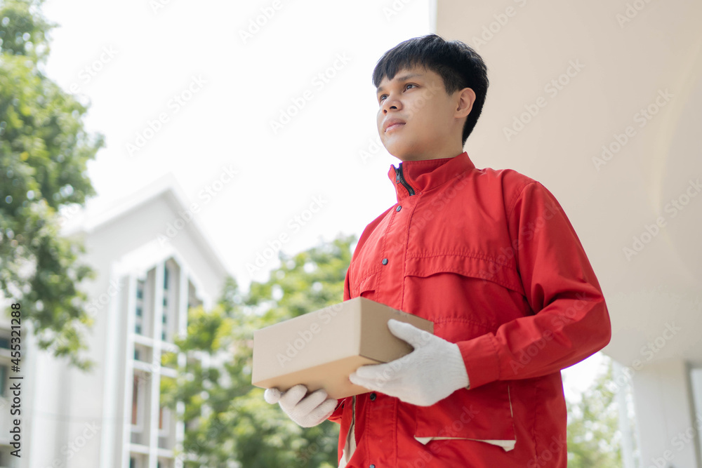 Parcel delivery concept the mailman wearing red uniform and gloves from ...