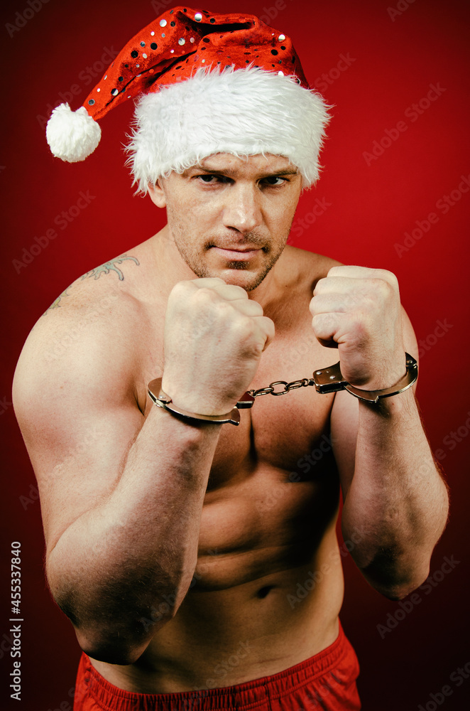 Sexy Santa Claus in handcuffs. Stock Photo | Adobe Stock